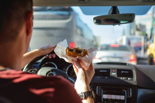 Eating While Driving: Is It Illgeal? | Quirk Law Group